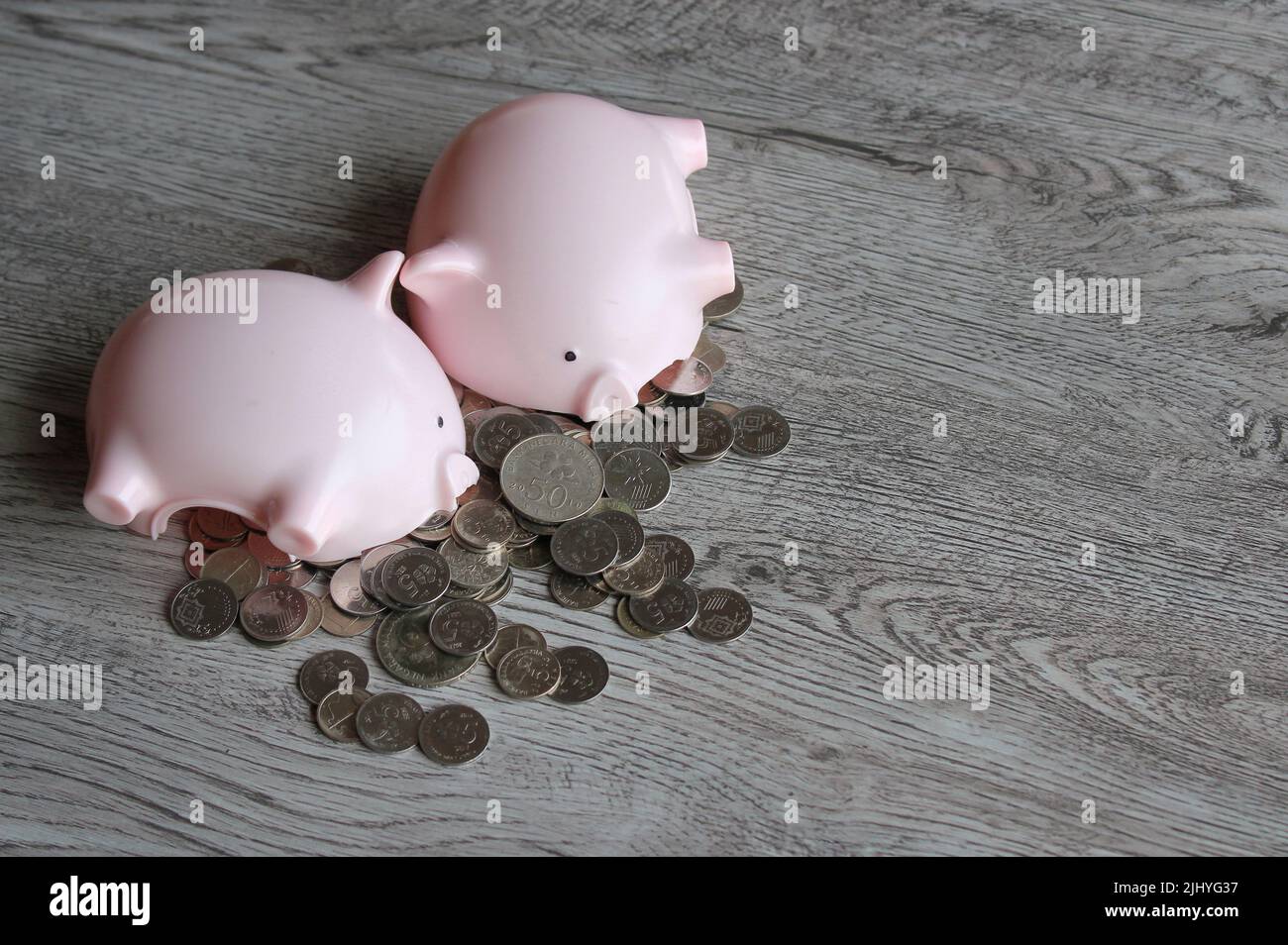 Broken piggy bank and coins on wooden table with copy space. Financial ...