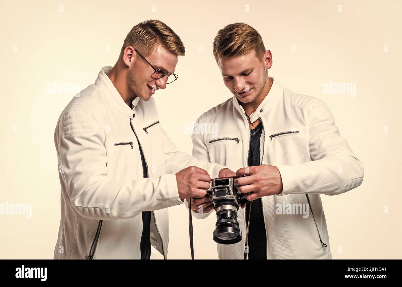 young twin brothers photographer with similar appearance make photo ...