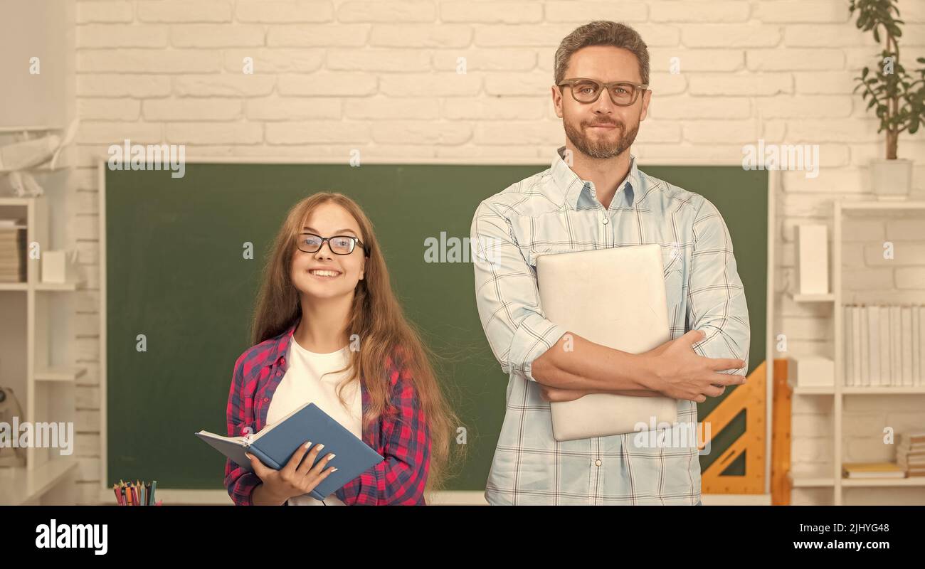 happy pupil and tutor with computer. father and teen girl study ...