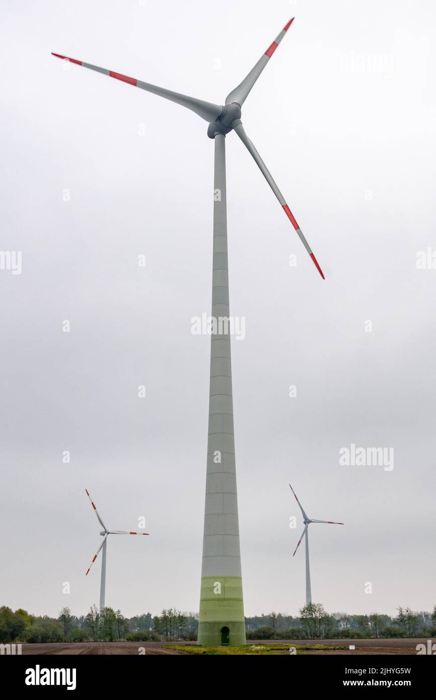 A vertical shot of a windmill - sustainable climate visuals Stock Photo ...