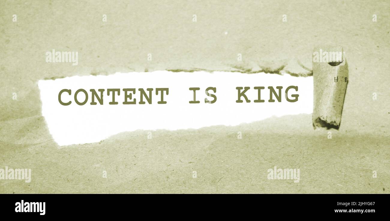 Content is king -message written under torn paper. Corywriting ...