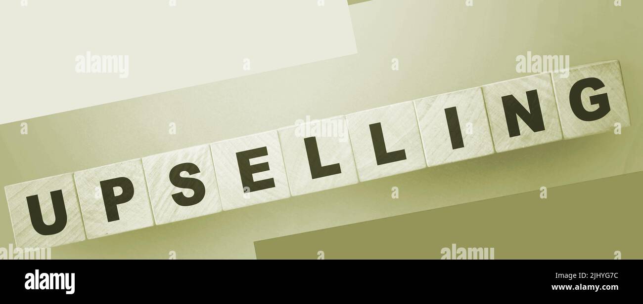 Word UPSELLING on wooden cubes on green gradient background. Business ...