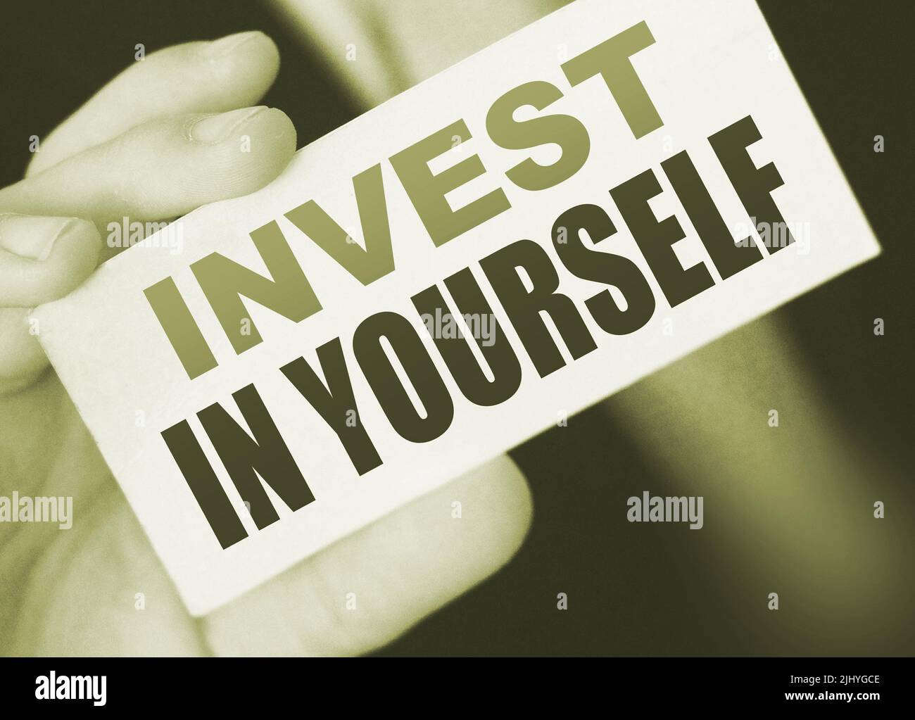 Invest in Yourself message on business card shown by a businessman ... Invest in Yourself message on business card shown by a businessman ...