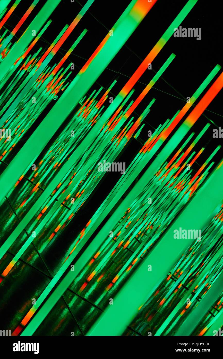 Angled abstract LED light poles in orange and green Stock Photo - Alamy