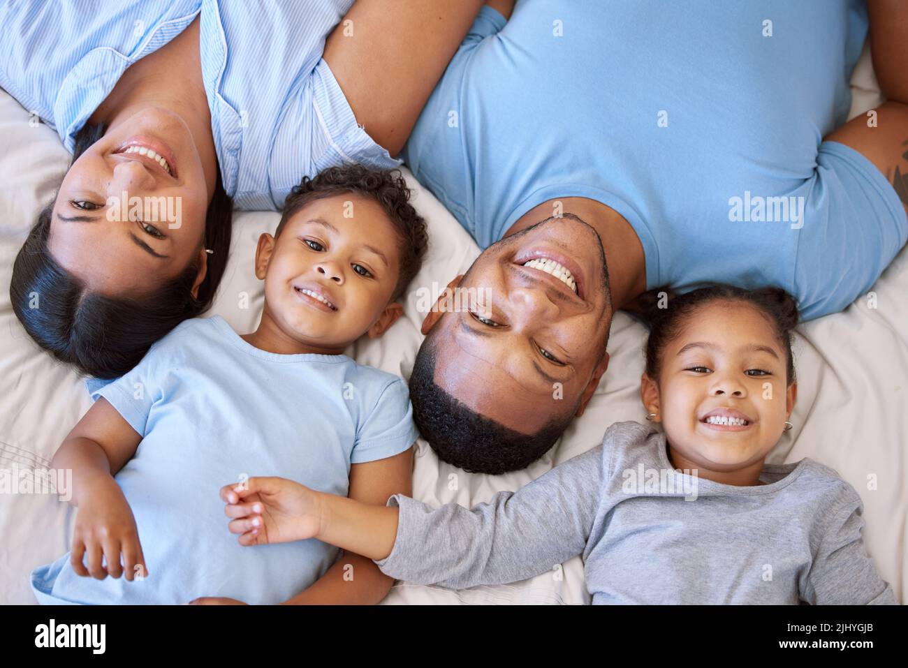 Happy mixed race family relaxing together and bonding at home. Little ...