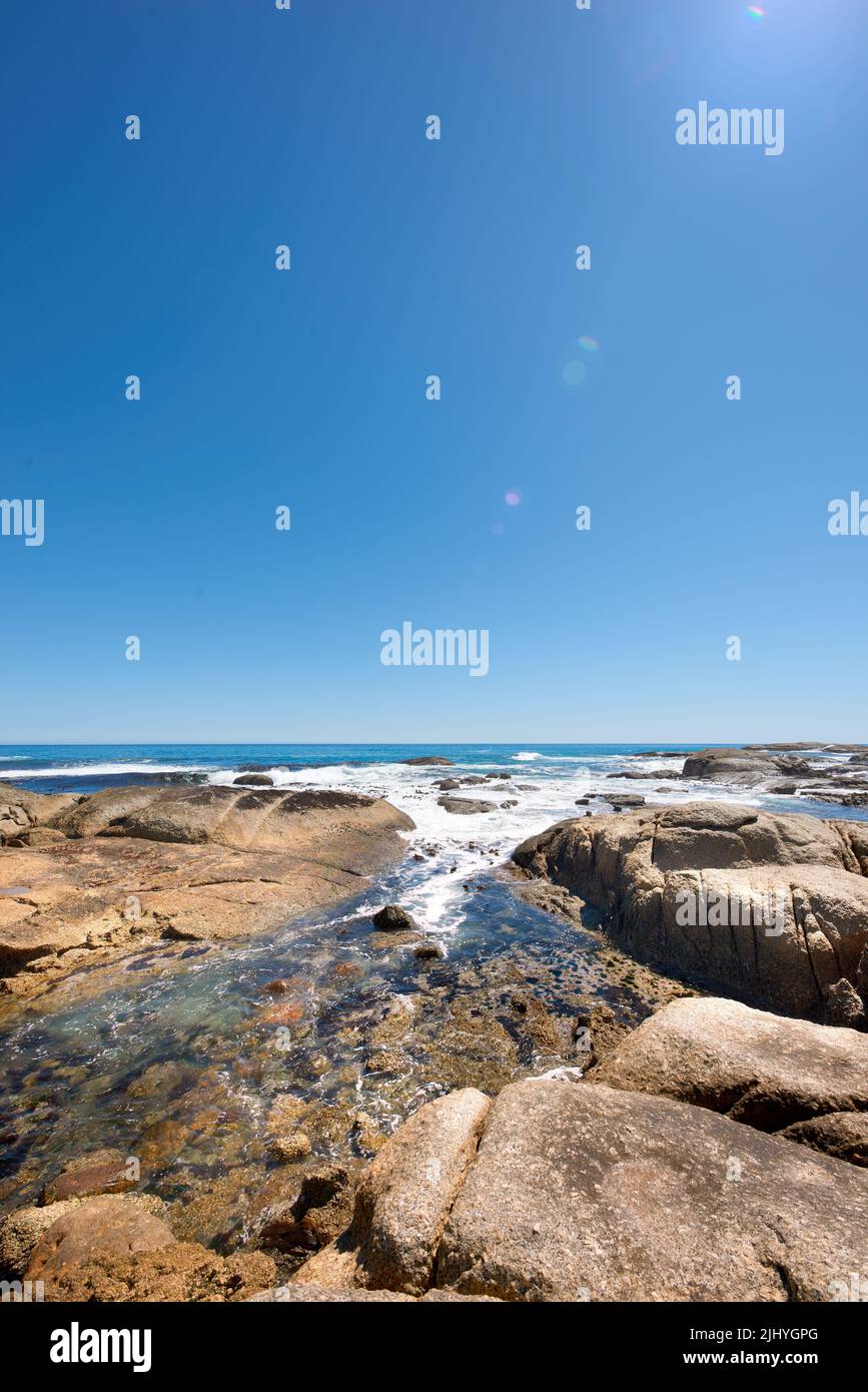 Big rocks in the ocean under a clear blue sky with copy space ...