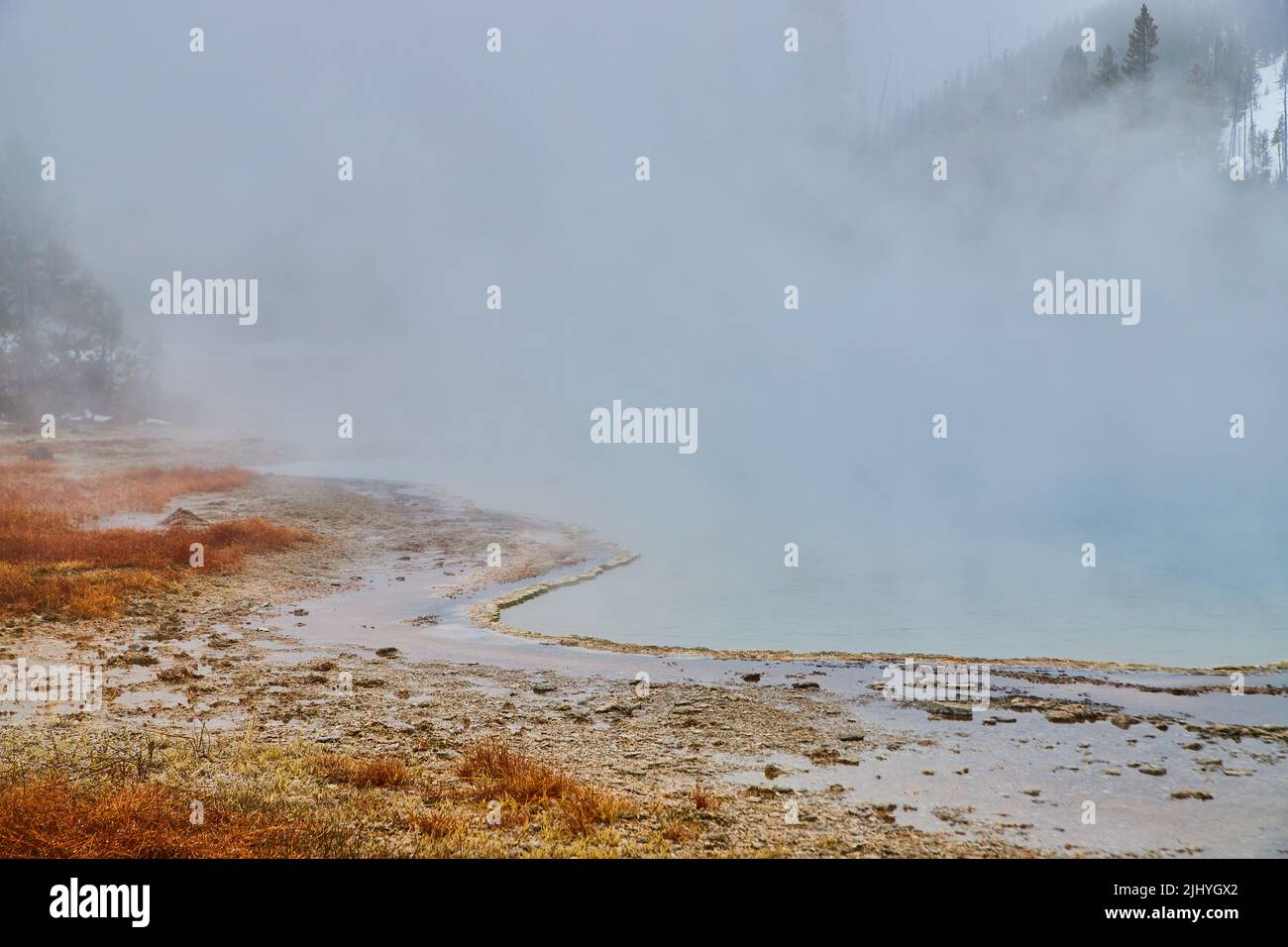 Yellowstone pools in spring covered in sulfuric steam Stock Photo - Alamy
