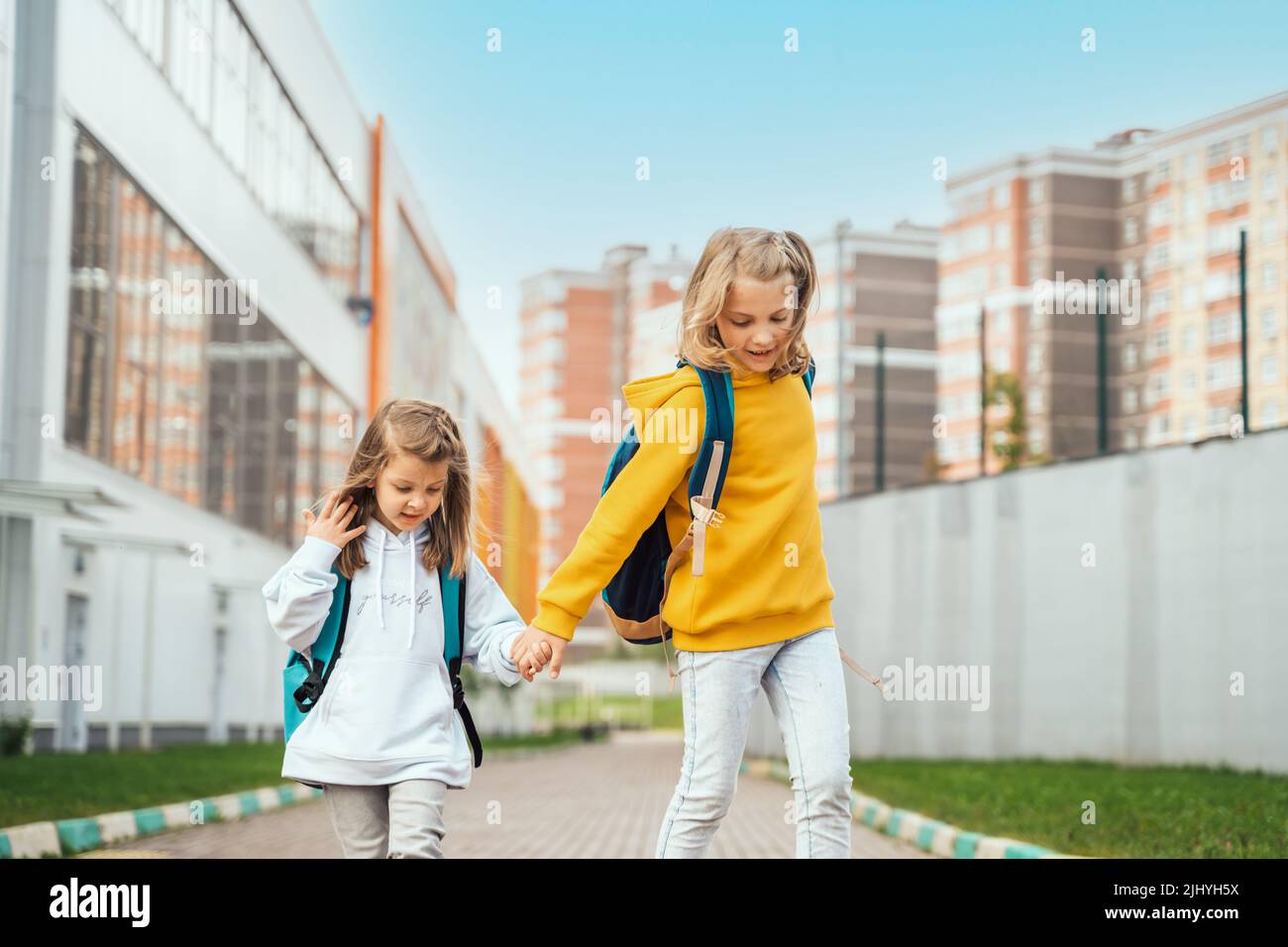 Back to elementary,primary school.Little girls,sisters with big ...