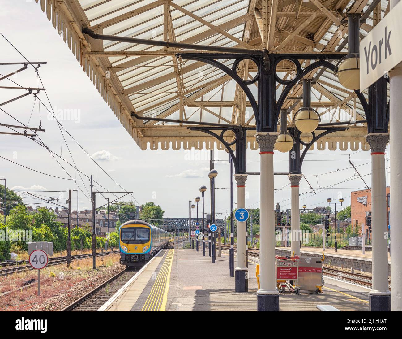 A train departs from a railway station. It passes the end of a platform ...