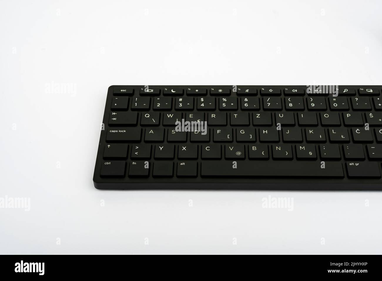 A low-angle shot of a computer keyboard isolated on a white background ...