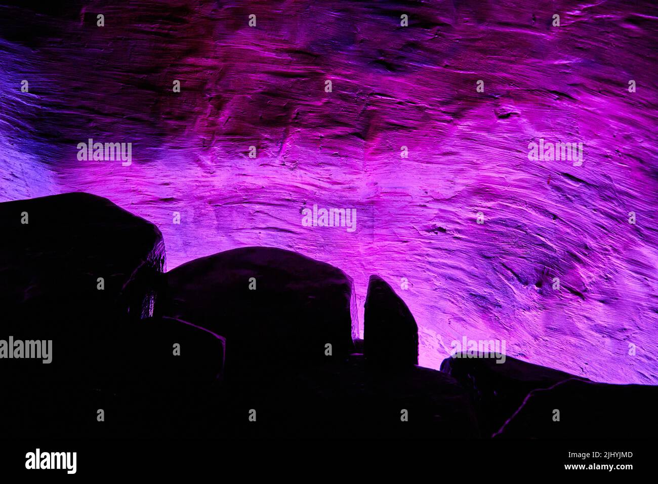 Purple glow with rocky silhouette in art display Stock Photo - Alamy