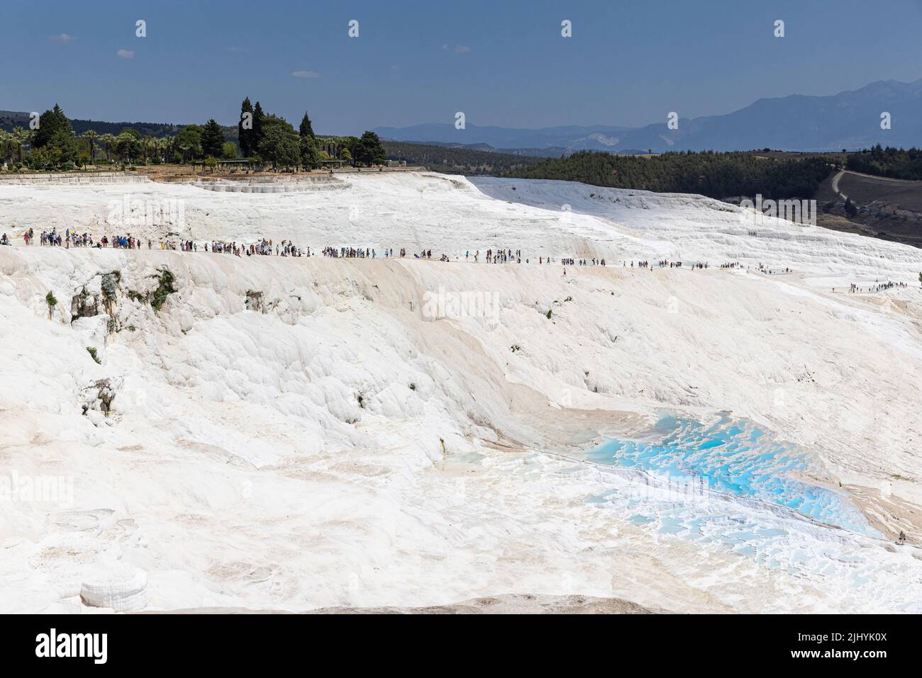 view of pamukkale natural limestone pools, crowd of tourists. Turkey ...