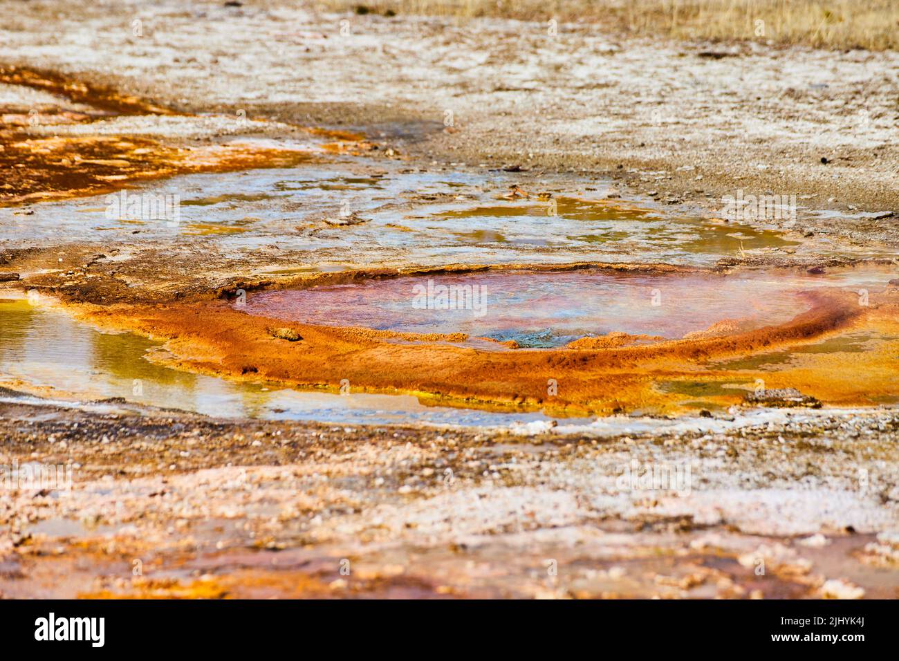 Yellowstone spring from lower angle with orange layers Stock Photo - Alamy