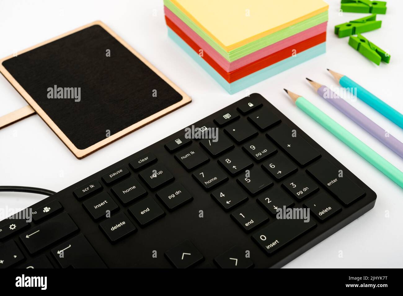 A low-angle view of a workspace with a computer keyboard and office ...