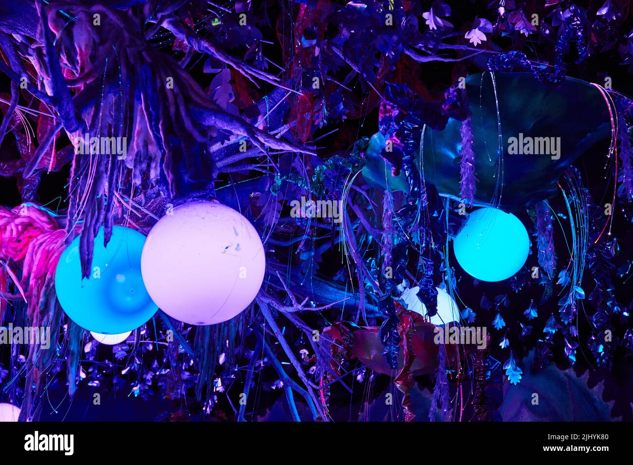 Neon lights and orbs on tree in art gallery Stock Photo - Alamy