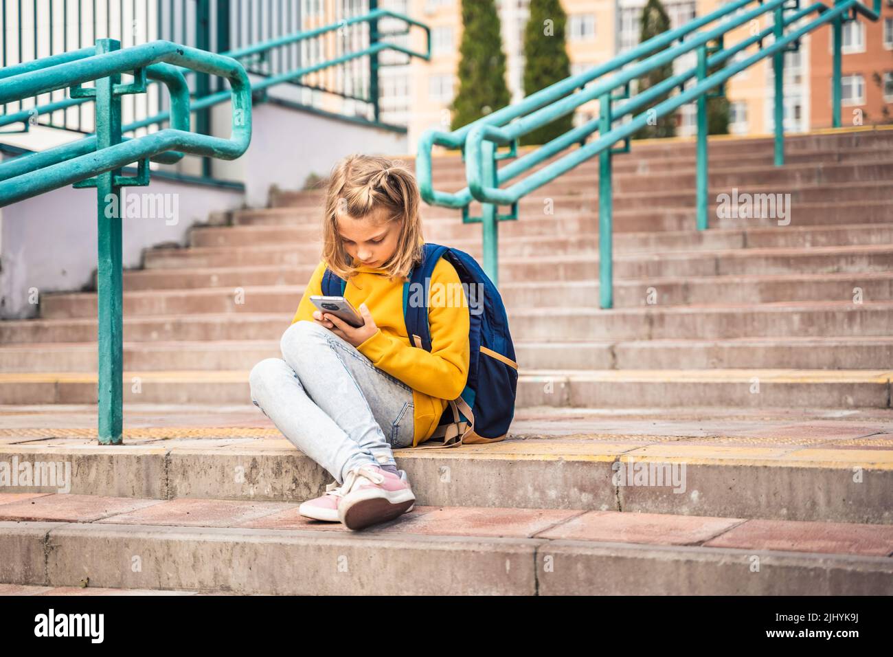 Back to elementary, primary school. Little girl with backpack,mobile ...