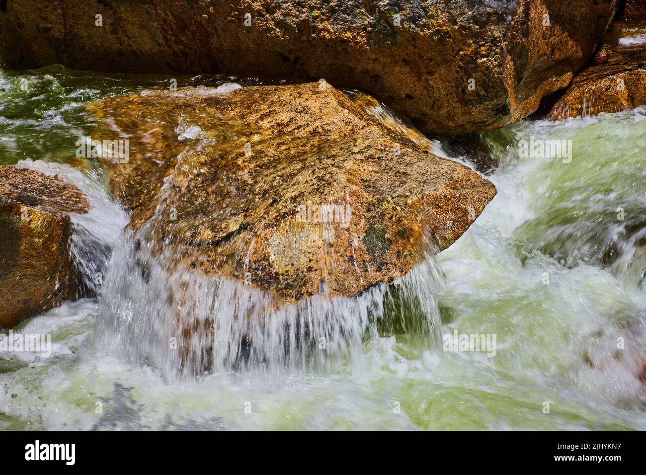 Water pouring in river over outcropping of rock Stock Photo - Alamy