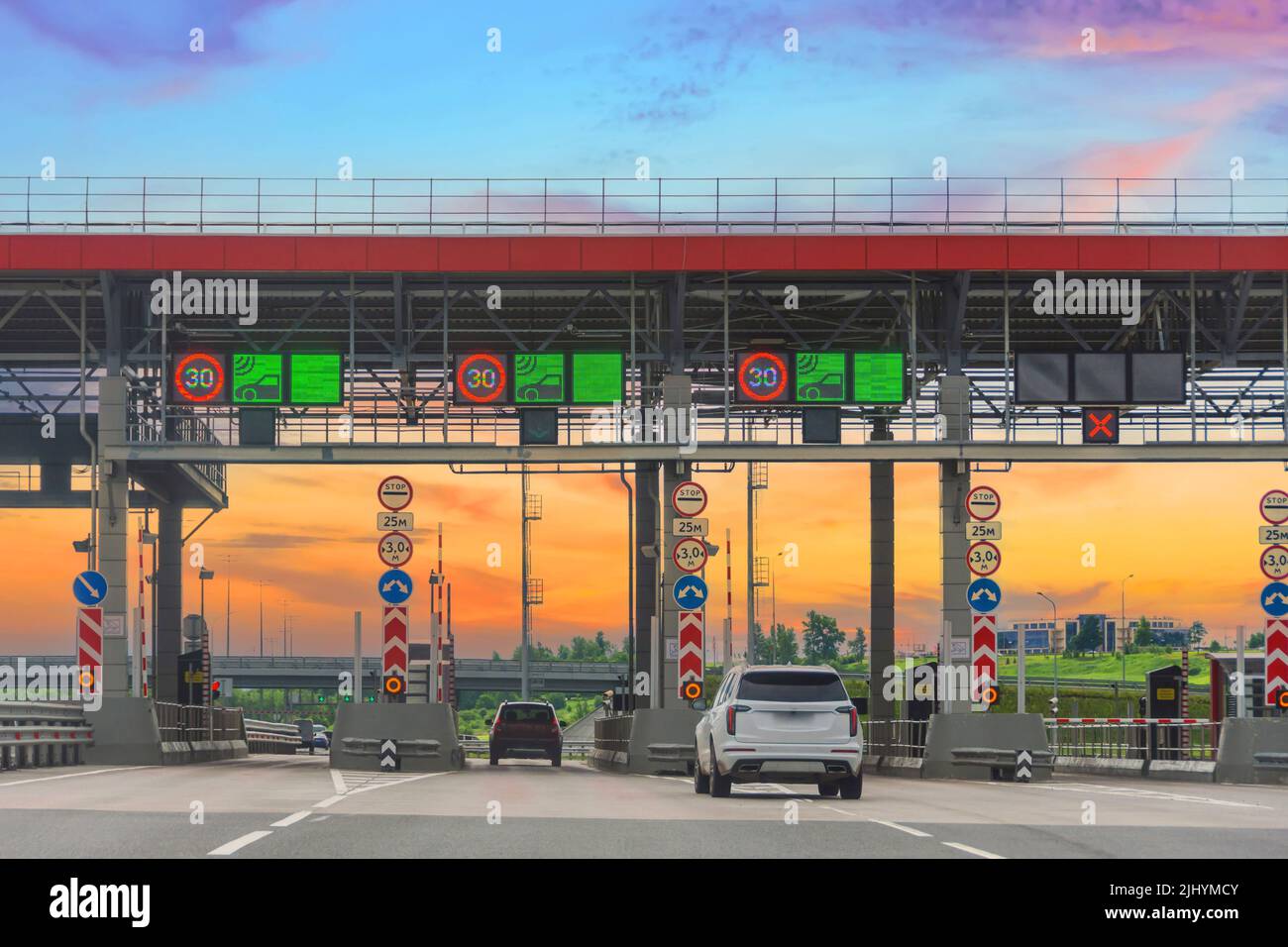 View with cars at the entrance to the toll road, limited by the barrier ...