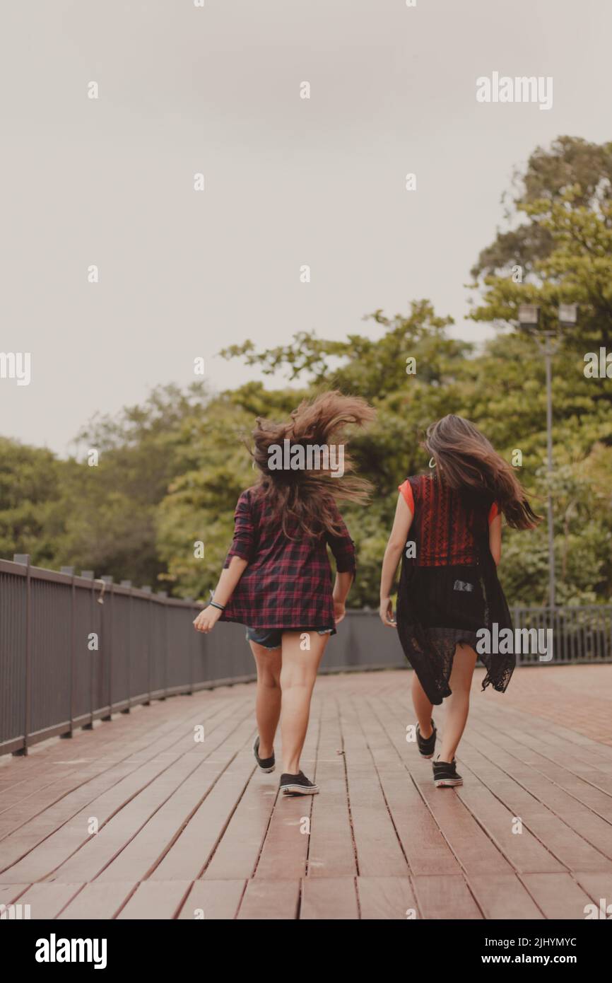 two young woman from the back walking with determination Stock Photo ...