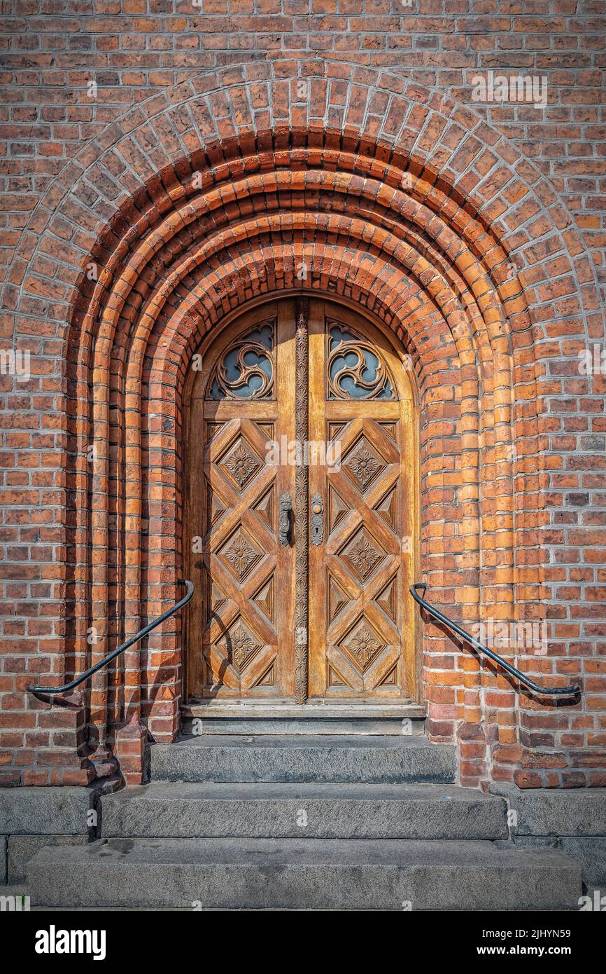 A vertical shot of an arch-shaped door to the town hall in Helsingor ...