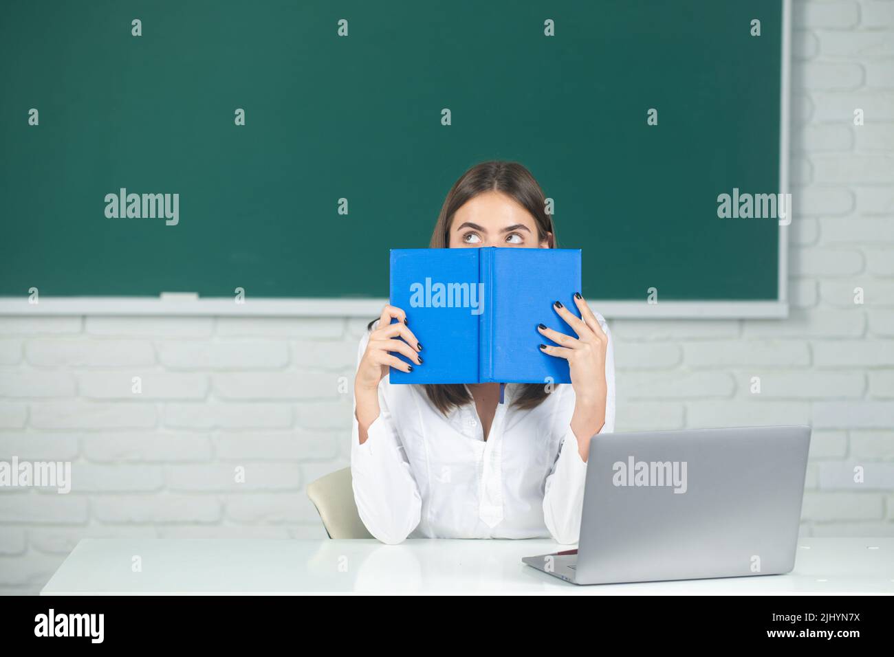 Portrait of a young, confident and attractive female student studying ...