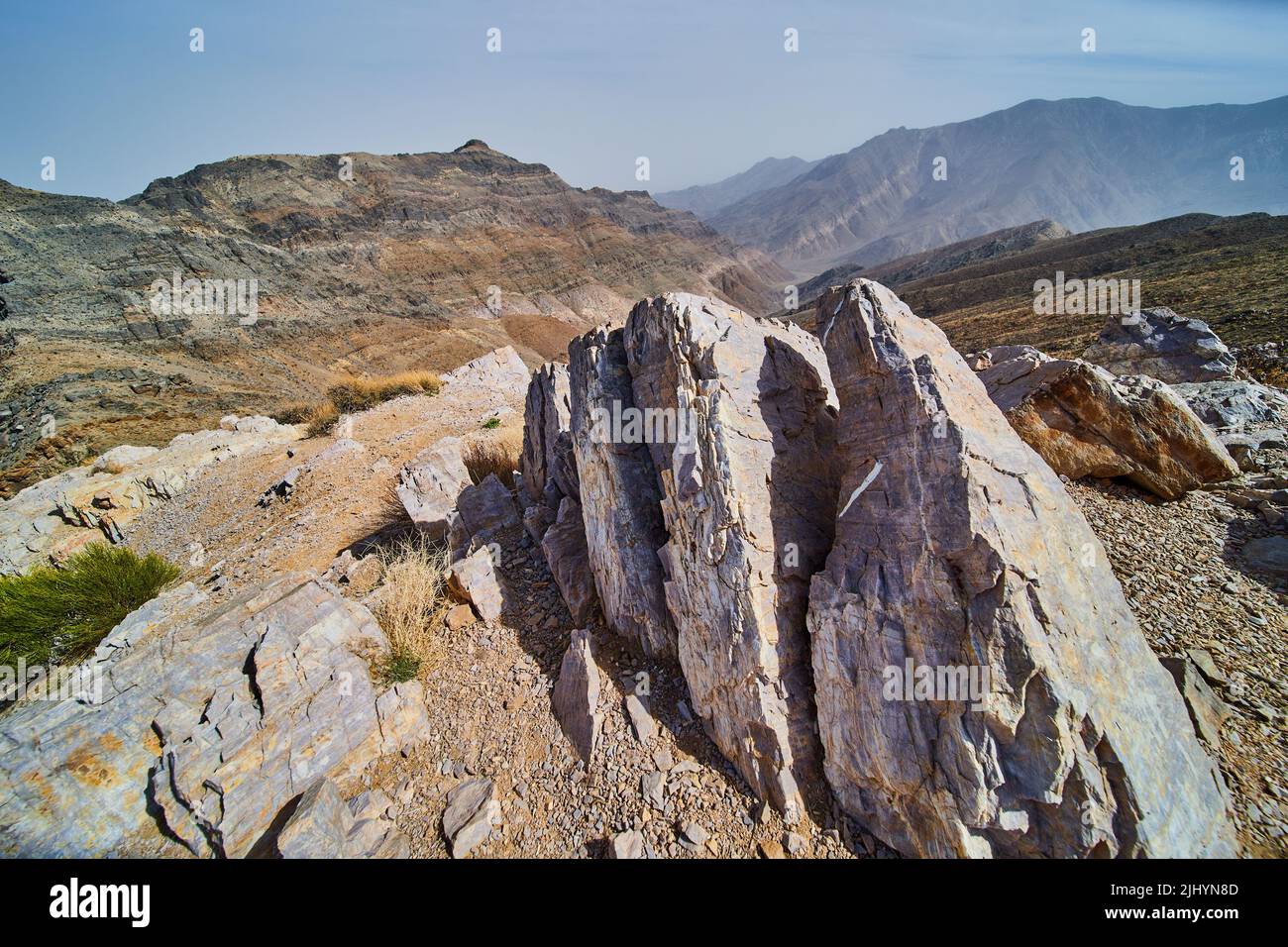 Walking path on mountain top winding through boulders Stock Photo - Alamy