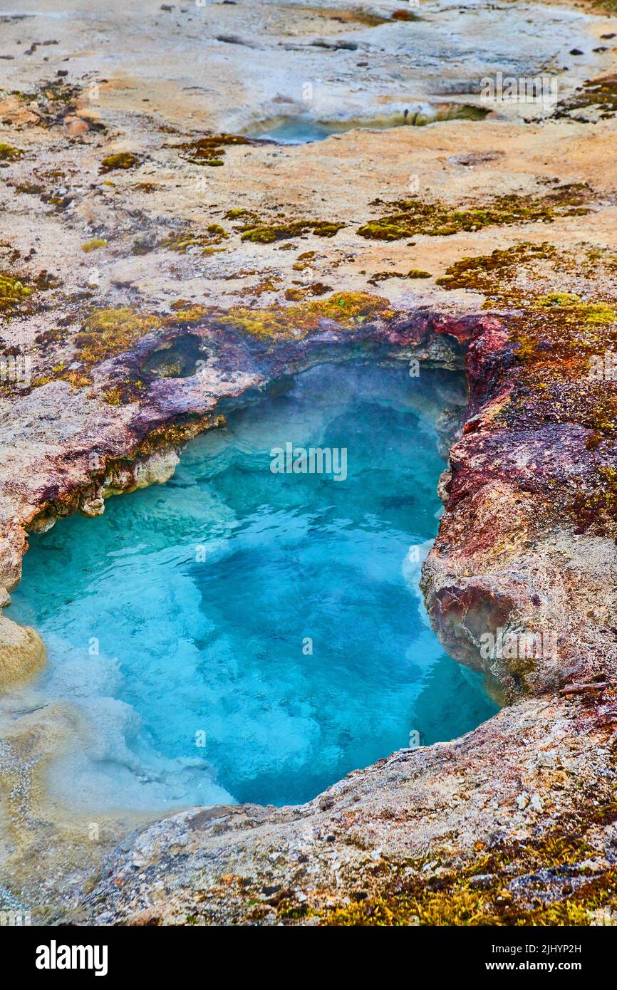 Vibrant blue alkaline thermal pool at Yellowstone in basin Stock Photo ...