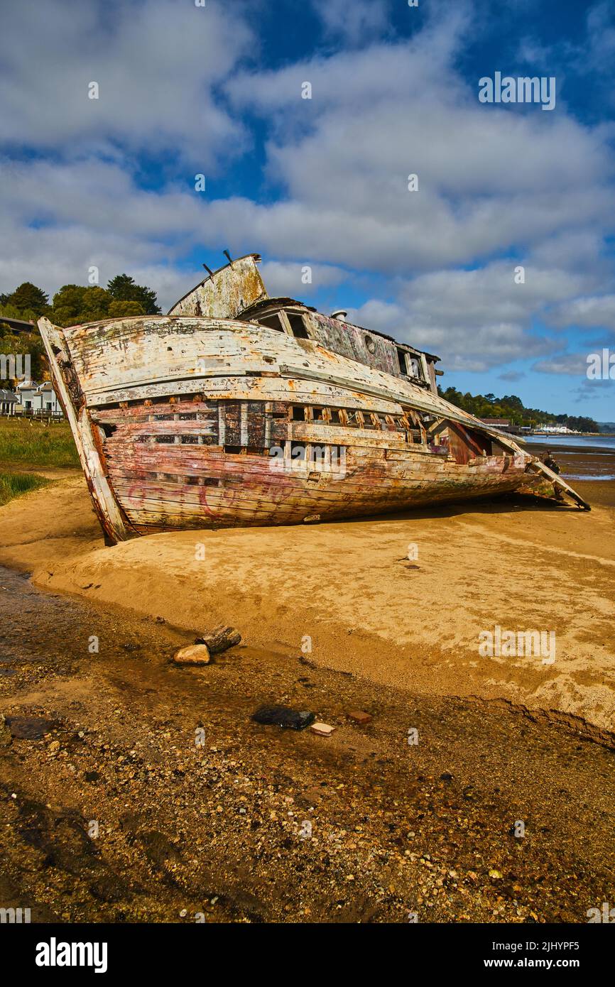 West coast sandy beach with falling apart shipwreck Stock Photo - Alamy