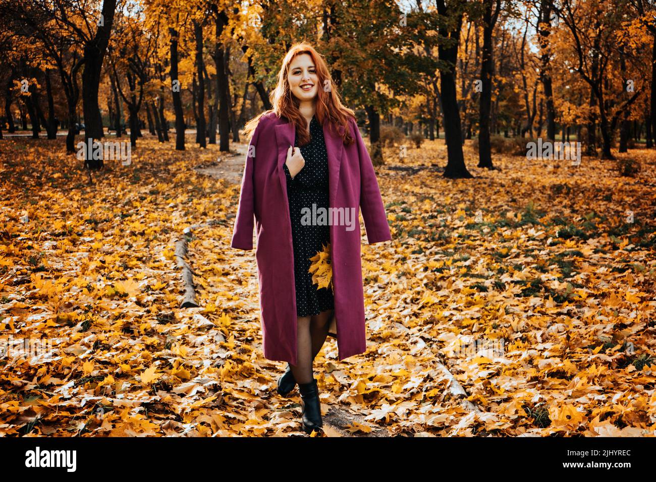 Outdoor autumn portrait of happy smiling plus size red hair woman in ...