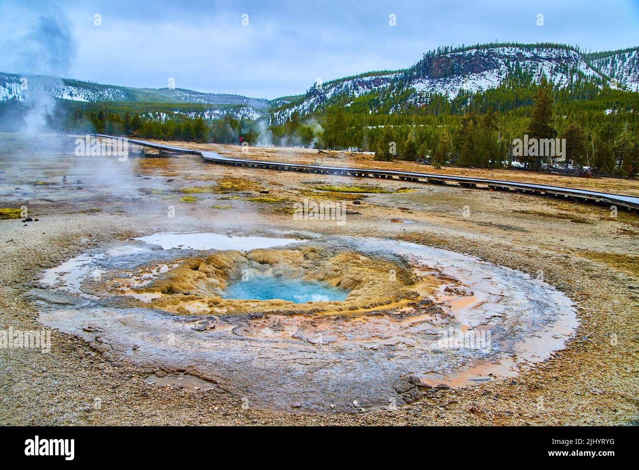 Yellowstone geyser with stunning layers and sulfur steam in winter ...