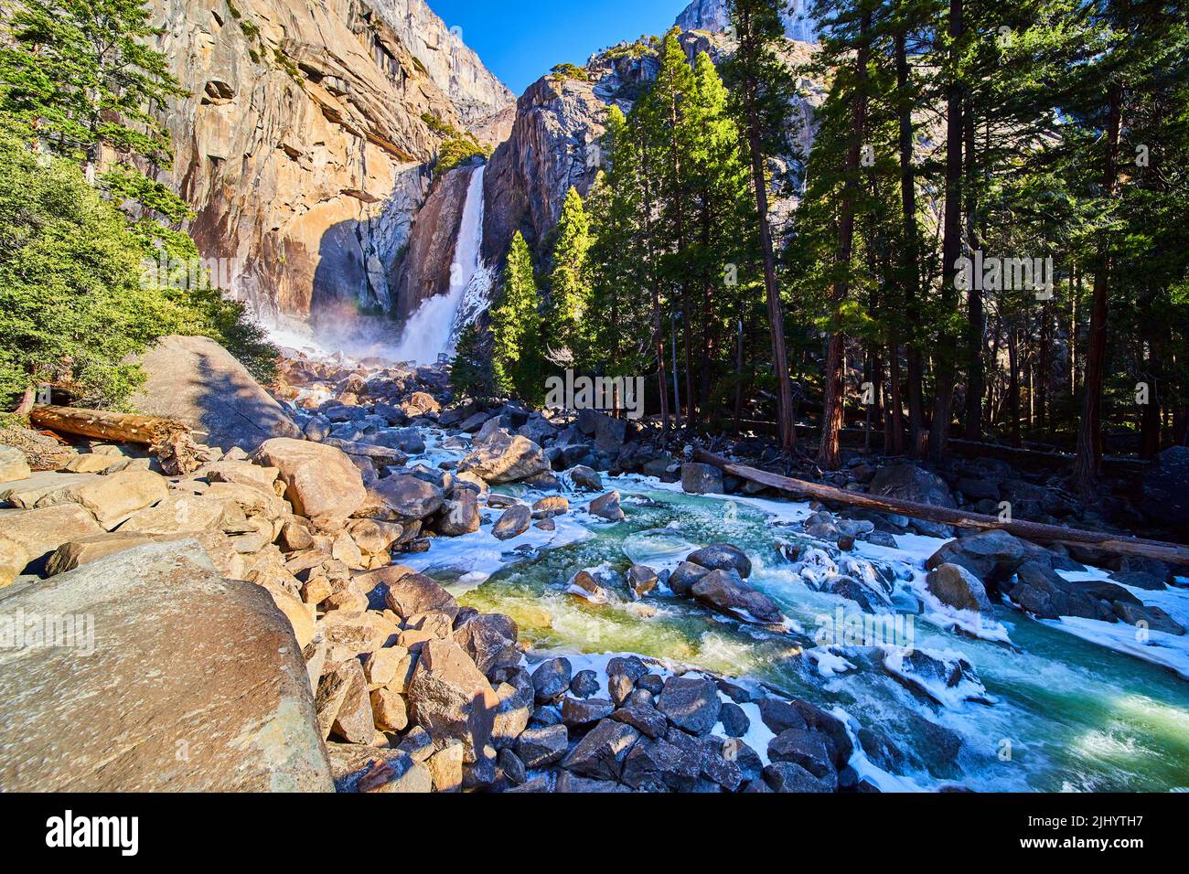 Yosemite Lower Falls in early morning with frosted rocks and ice cold ...