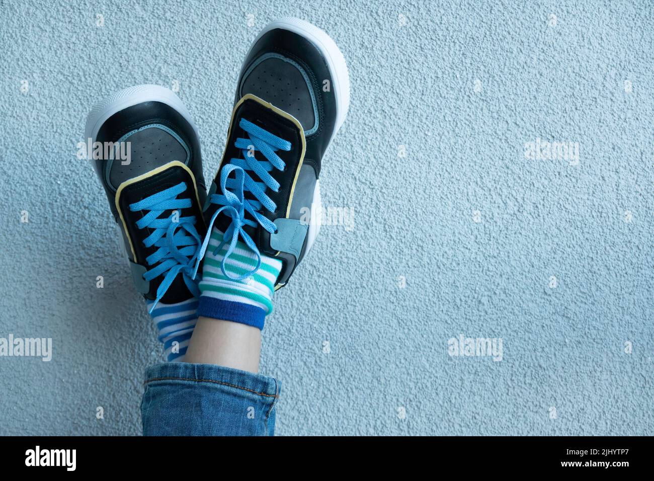 Kid wearing different pair of socks. Child legs up in mismatched socks ...