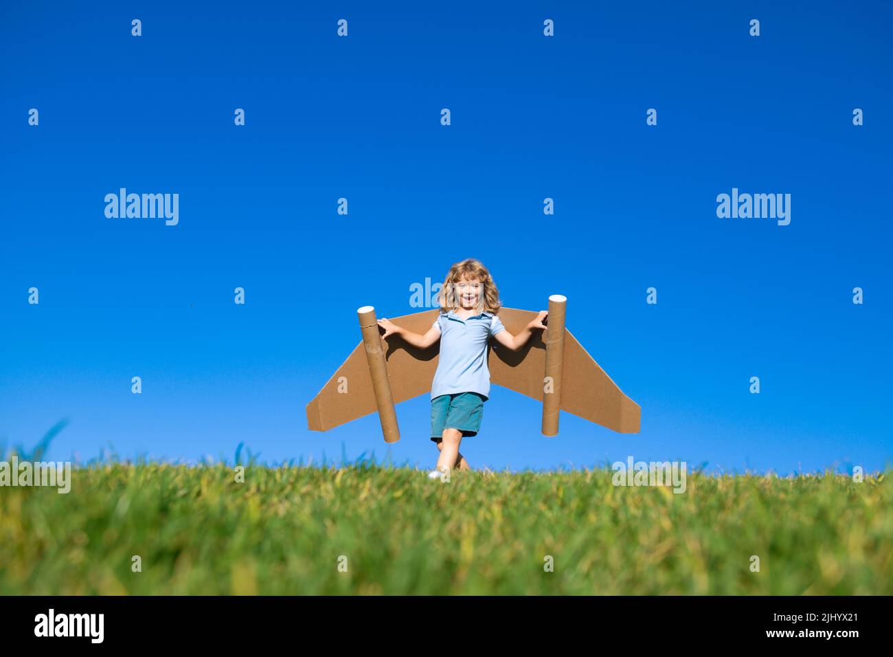 Dreams of travel. Child flying on jetpack with toy airplane on sky ...
