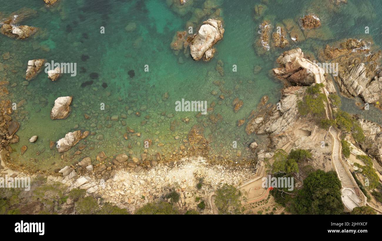 An aerial shot of huge rocks in the transparent water Stock Photo - Alamy