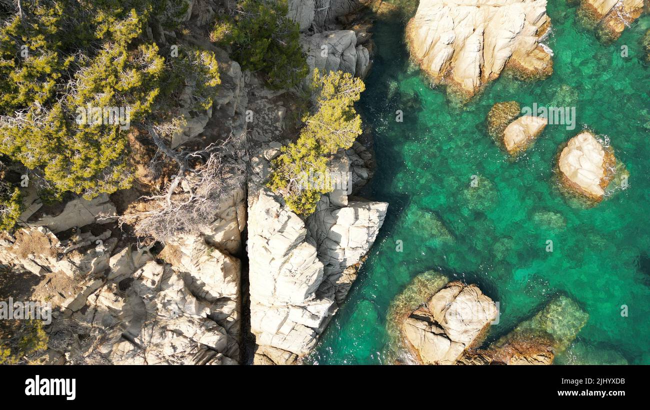 An aerial shot of huge rocks in the transparent water Stock Photo - Alamy