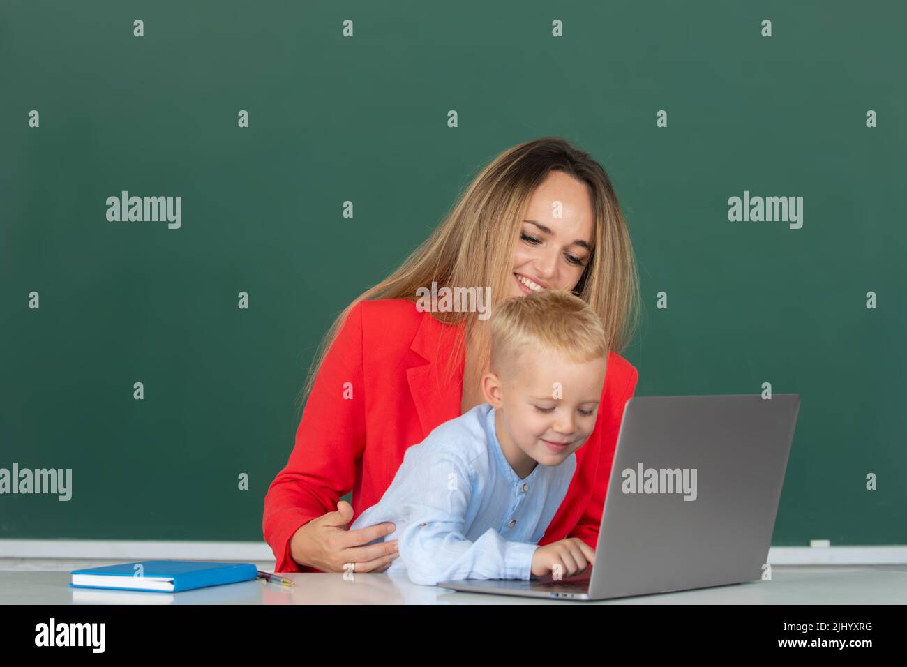 Mother and son learning. Online school. Teacher helping school child ...