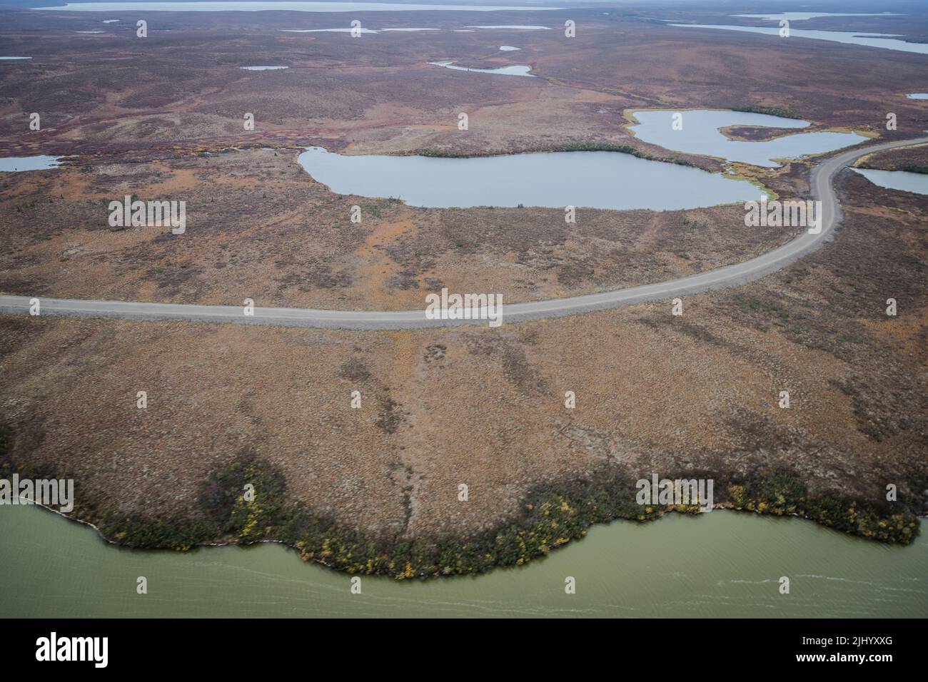 Aerial view of the all-weather gravel Inuvik-Tuktoyaktuk highway in ...