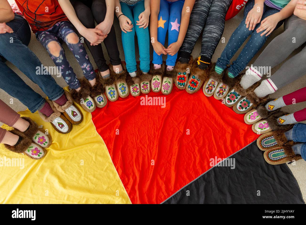 People wearing traditional Indigenous beaded moosehide slippers ...
