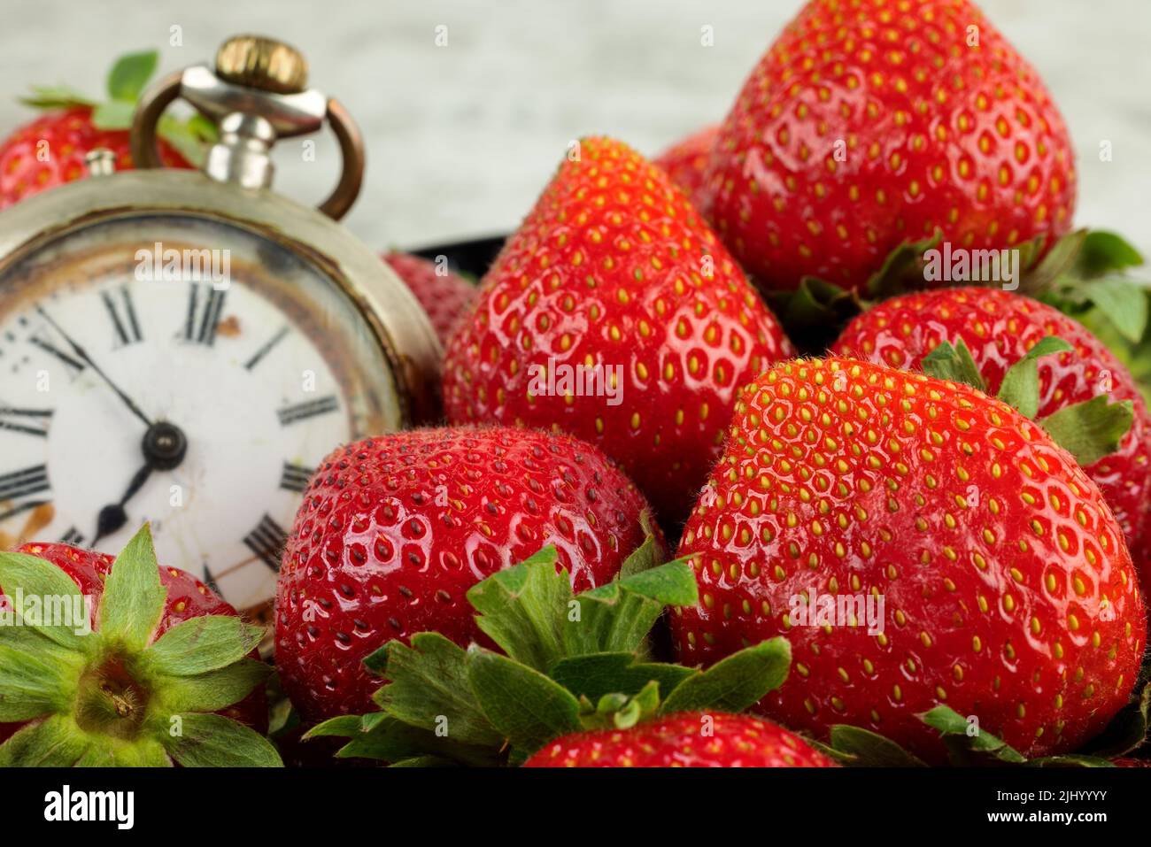 Strawberry time. Strawberries and old clock Stock Photo - Alamy