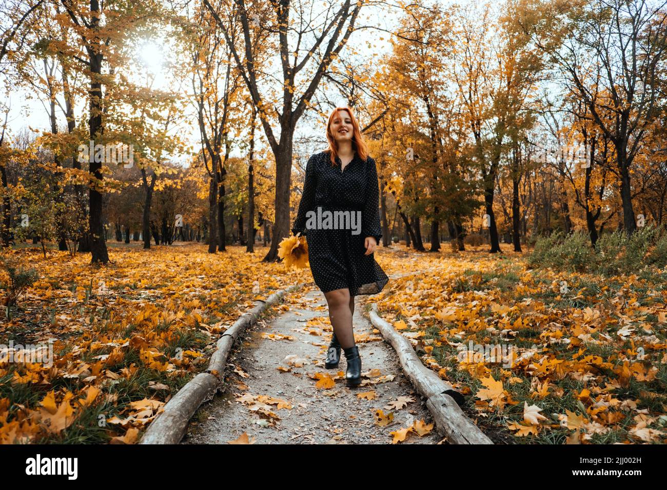Outdoor autumn portrait of happy smiling plus size red hair woman in ...