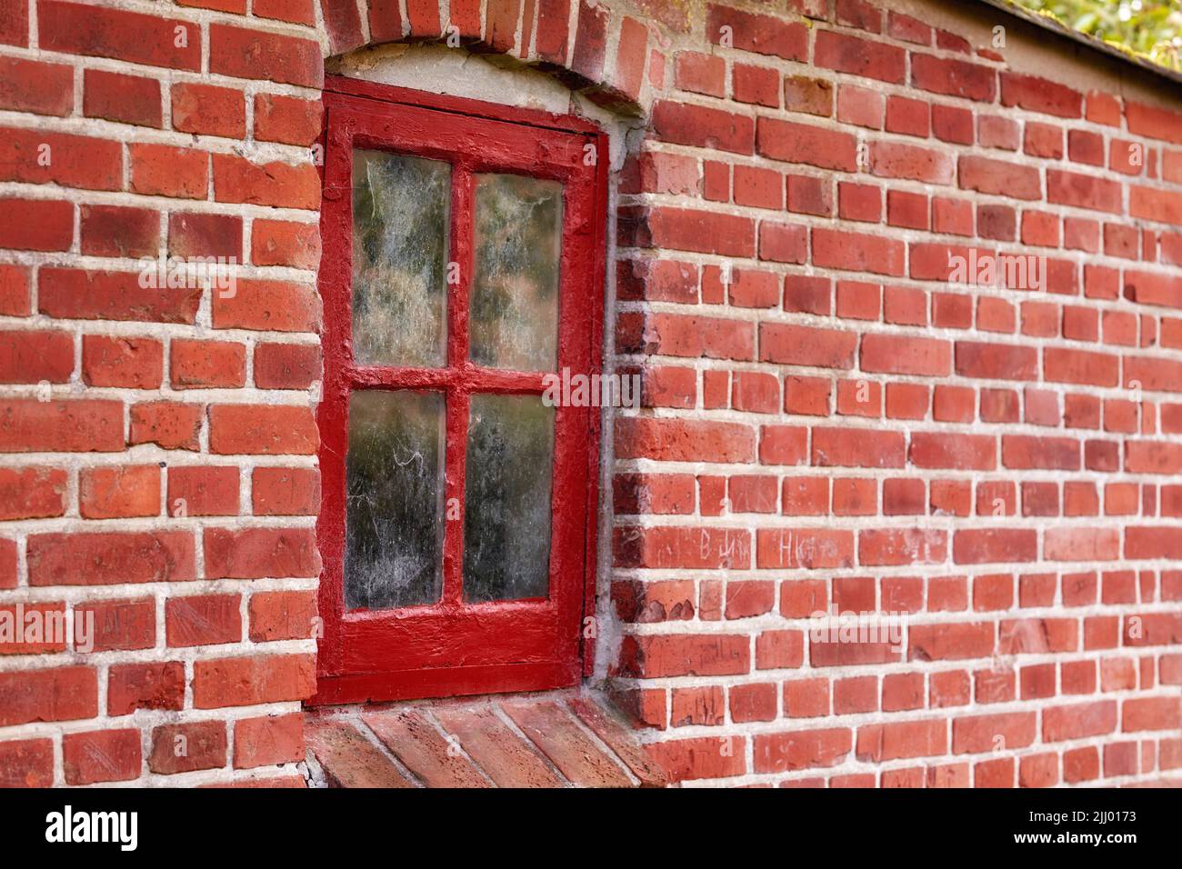 Old dirty window in a red brick house or home. Ancient casement with ...