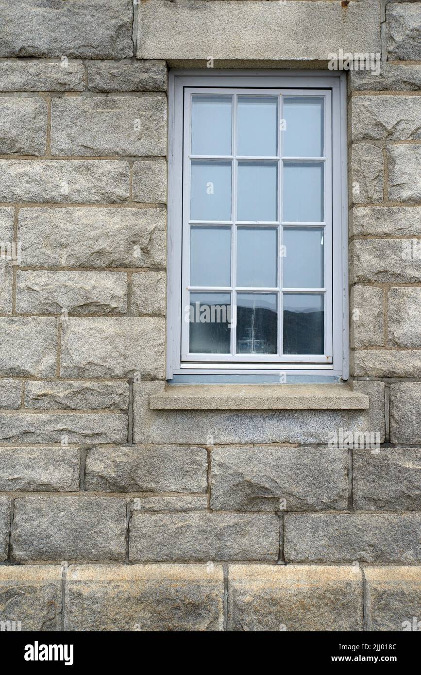 Shiny window and architecture of a grey brick wall. Exterior texture ...