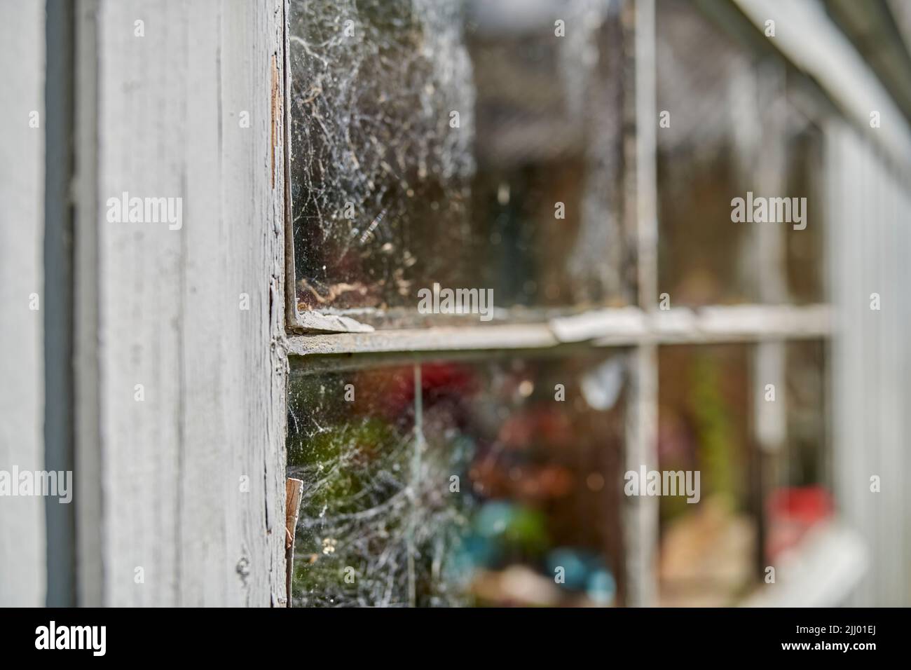 Old window. Abandoned windows being left dirty outside storage house. Damaged frames and ...