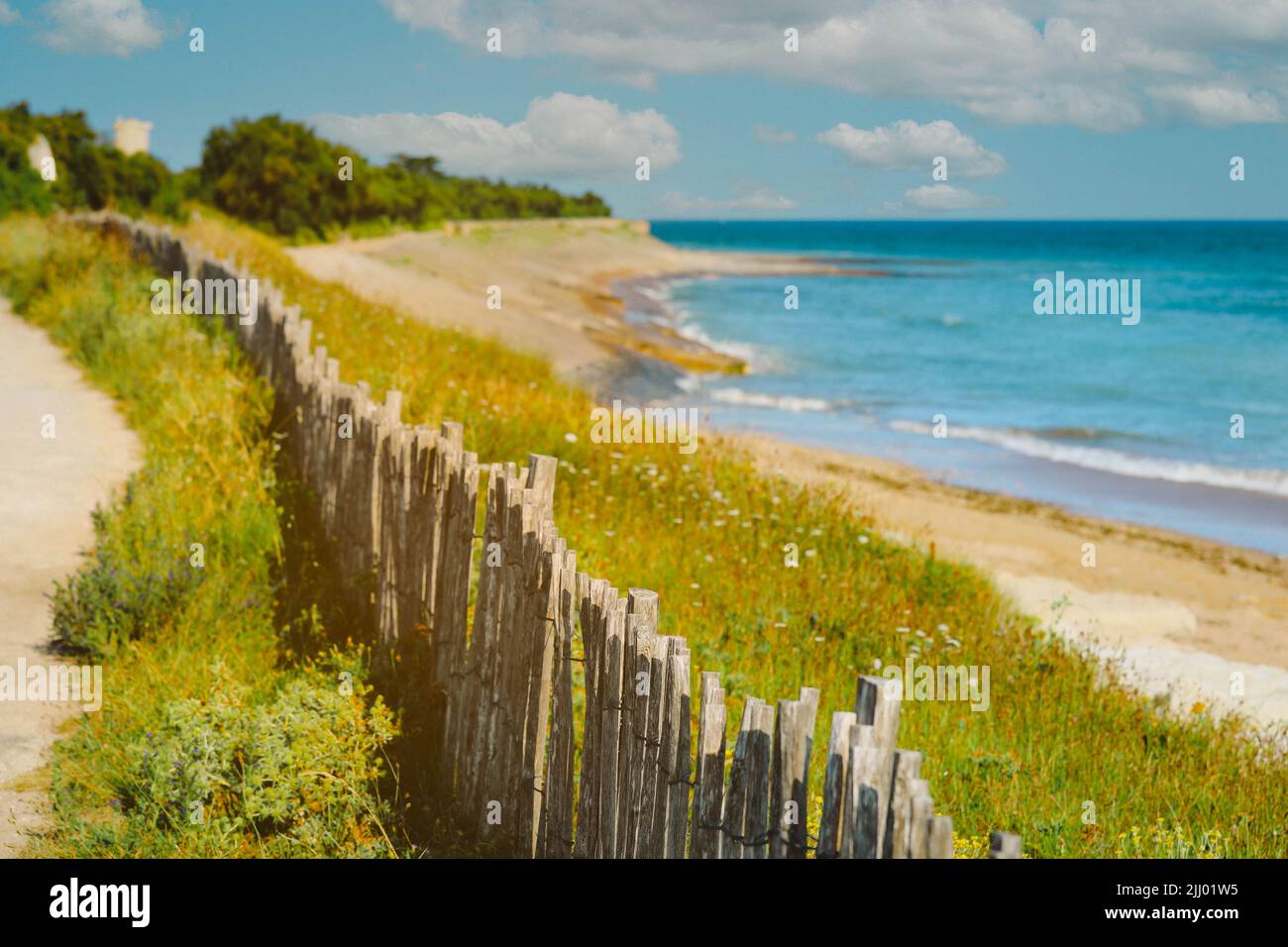 Selective focus on wooden fence, view of a dune with wooden fence in ...