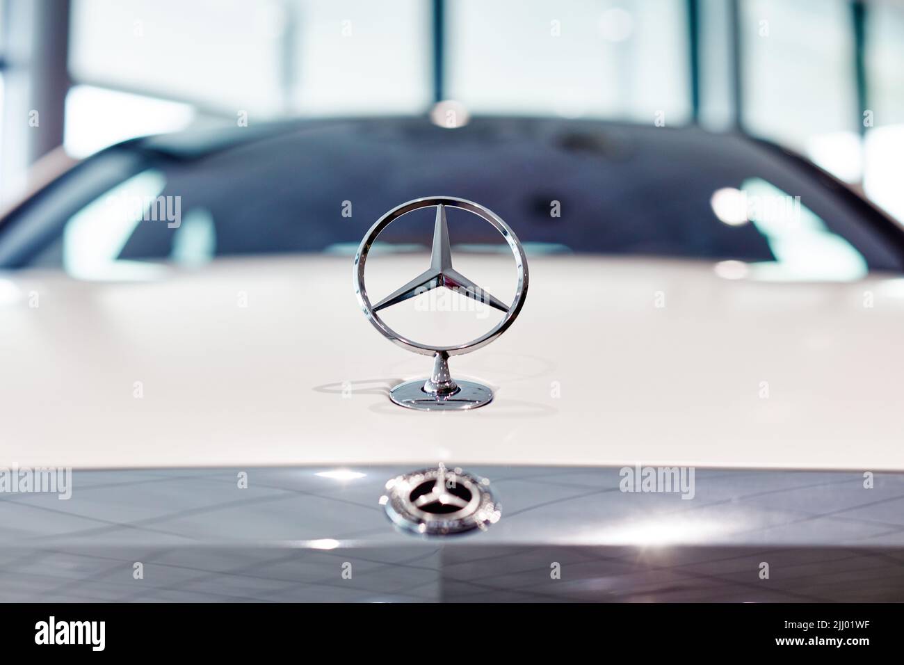 Mercedes star on the hood of a white Mercedes S-Class. Mercedes ...