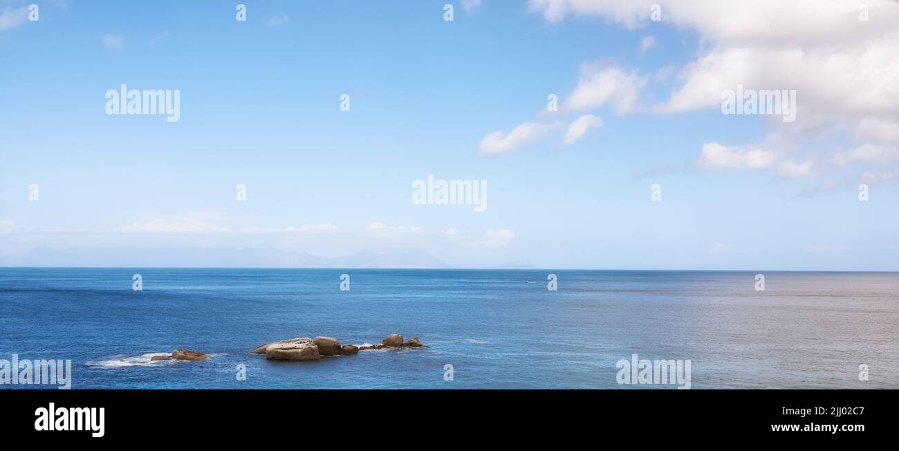 Beautiful view of a blue calm ocean on the rocky coast of Western Cape ...
