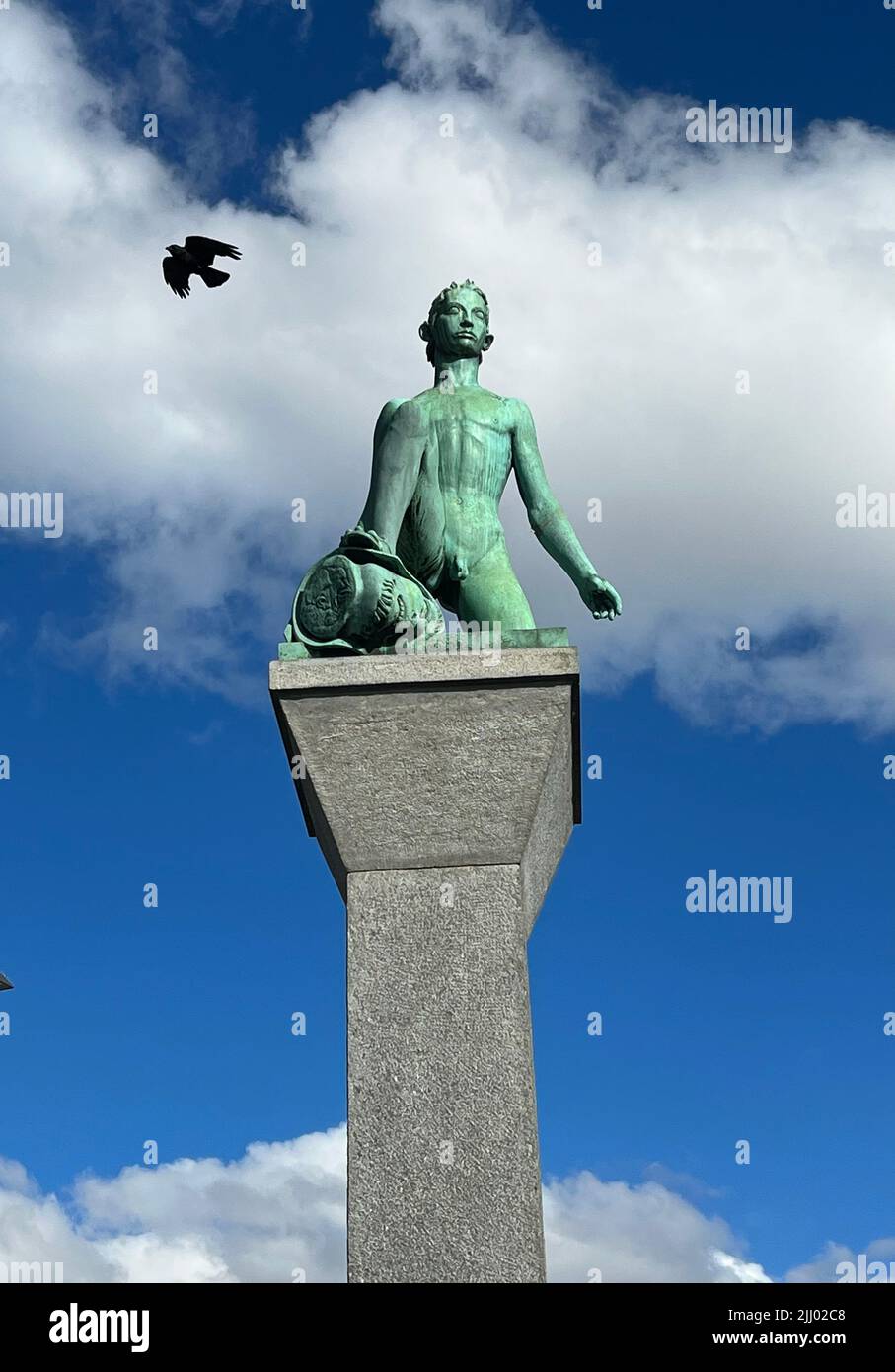 A vertical shot of David by Ivar Johnsson statue against blue cloudy ...