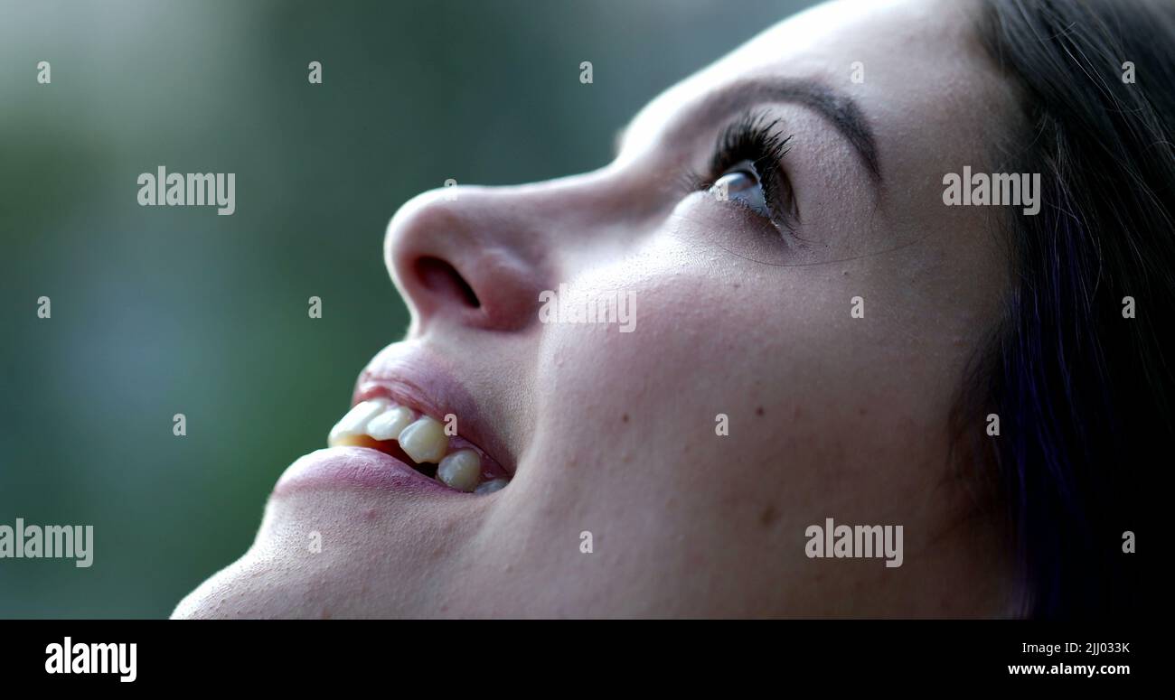 Happy woman looking up to sky with hope and faith smiling Stock Photo ...