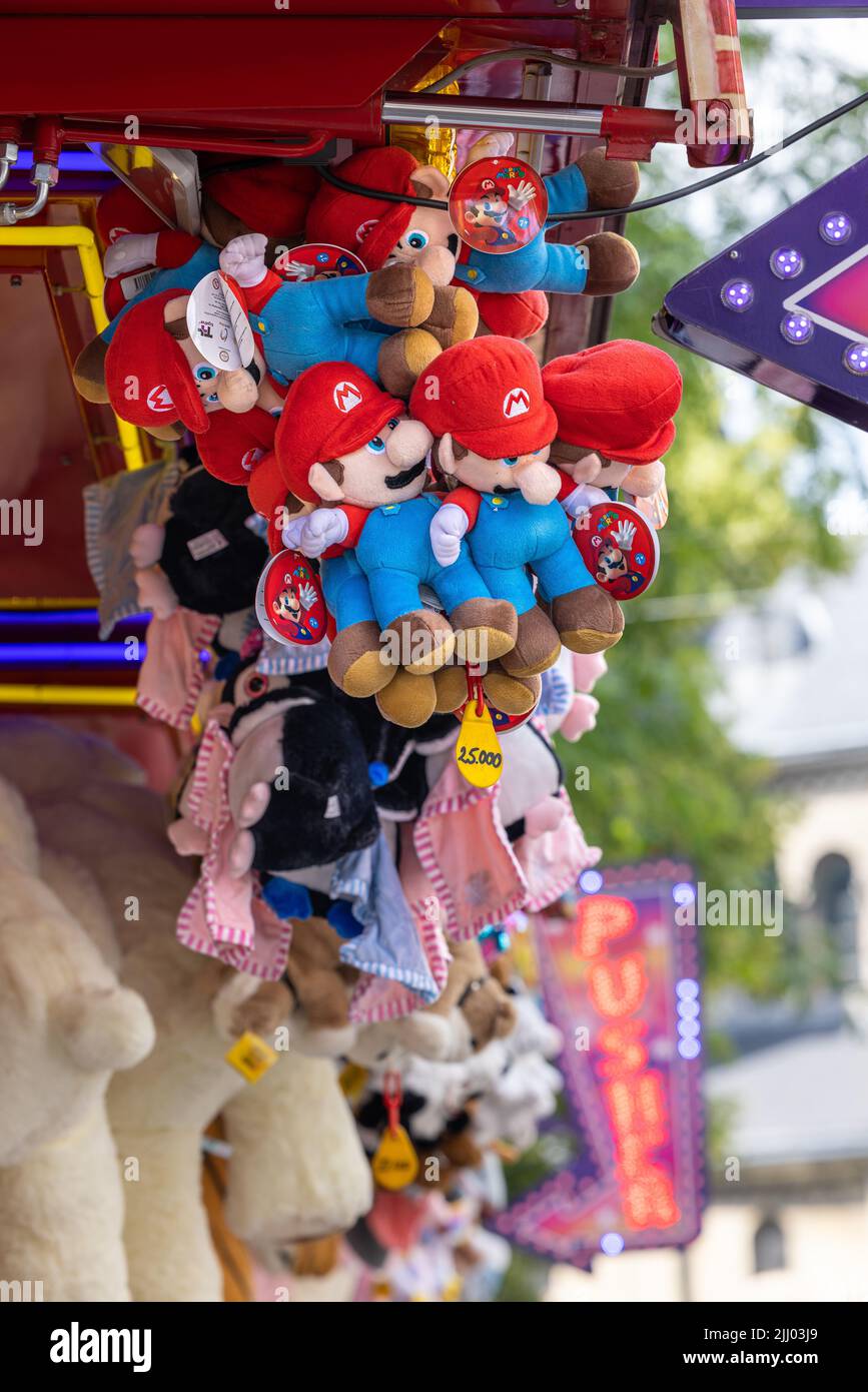 A vertical shot of Super Mario stuffed toys to be won at a fair or ...