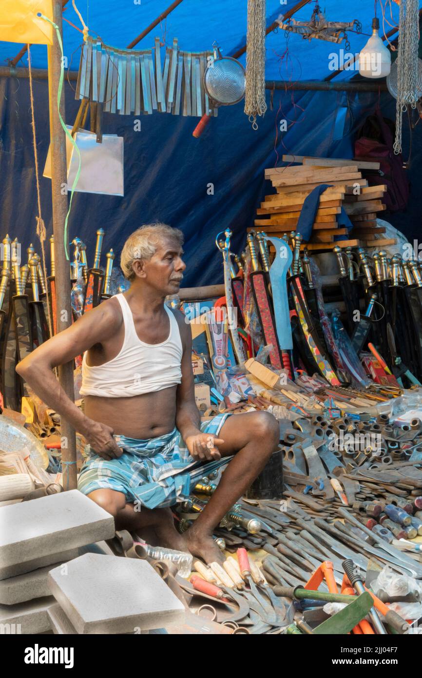 Traditional weapon vendor at village market Stock Photo - Alamy